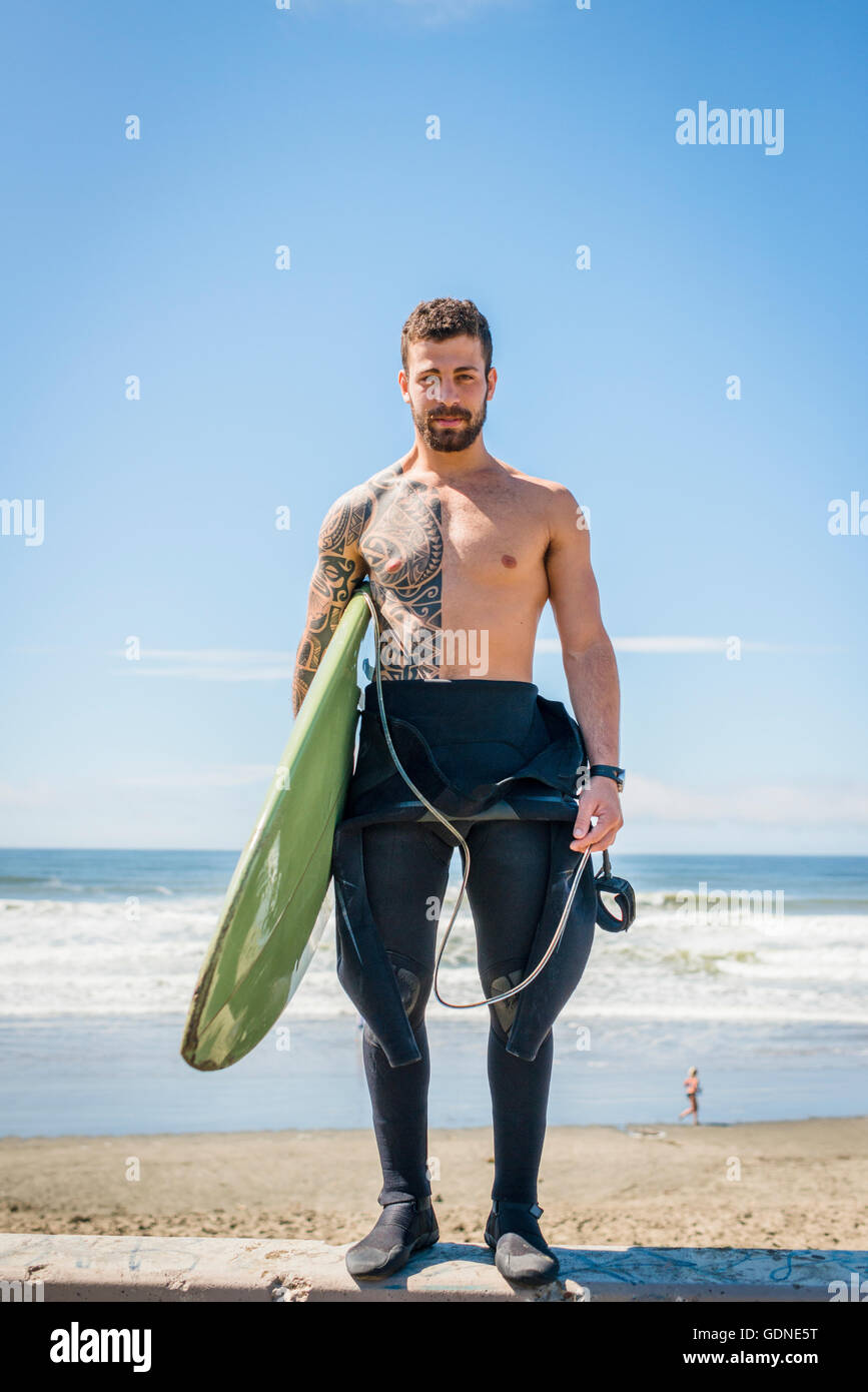 Surfer carrying surfboard, San Francisco, California, USA Stock Photo ...