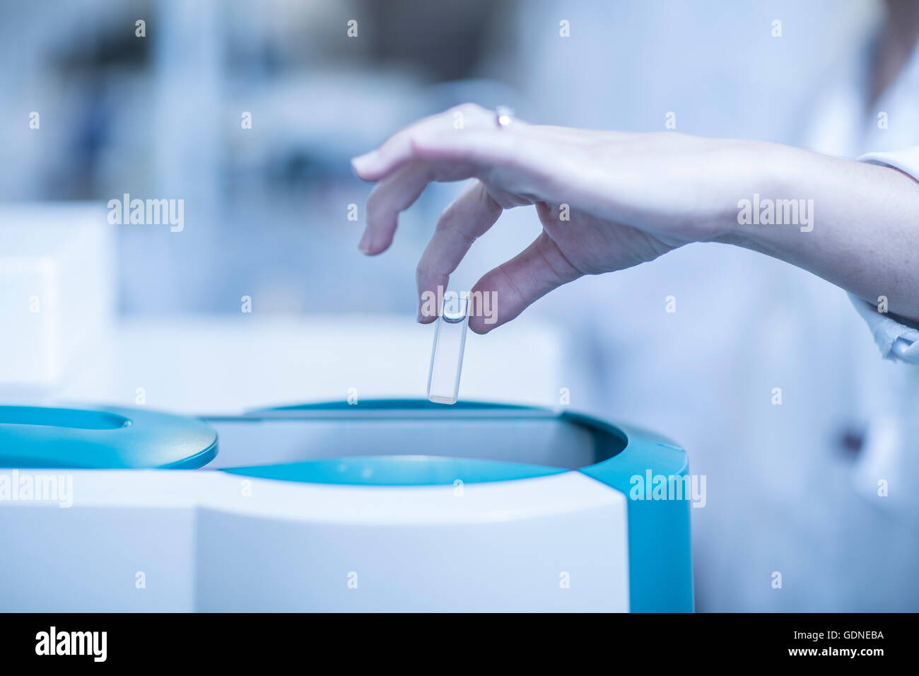 Lady scientist holds glass tube hi-res stock photography and images - Alamy