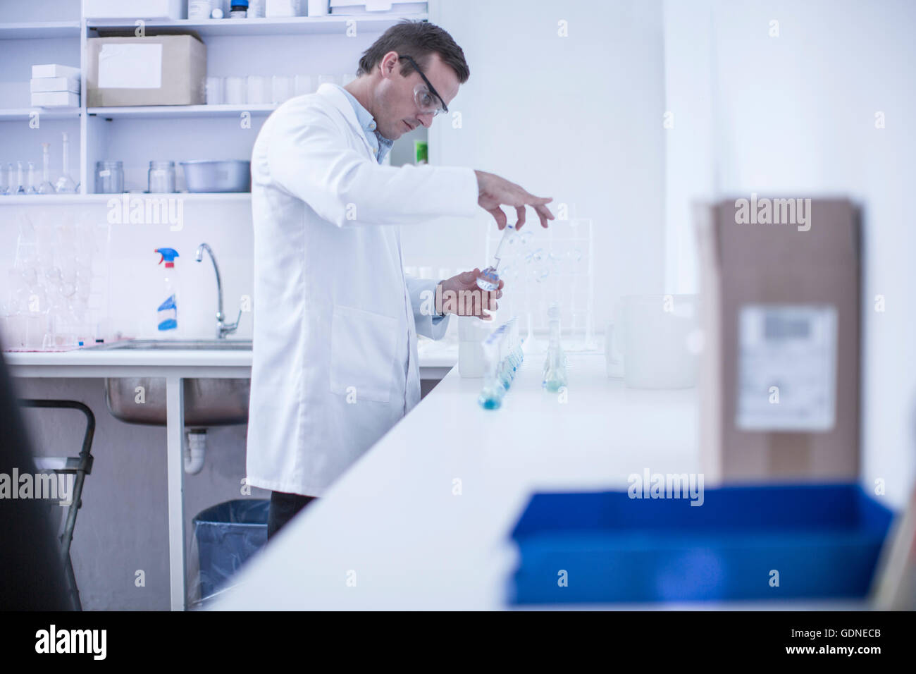 Man in laboratory, tightening lid on test tube, close-up Stock Photo ...