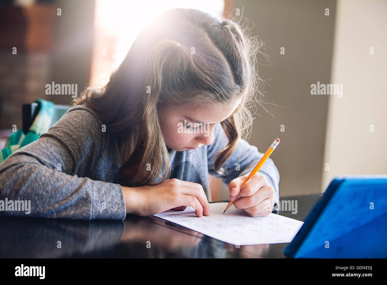 Girl at desk writing Stock Photo - Alamy