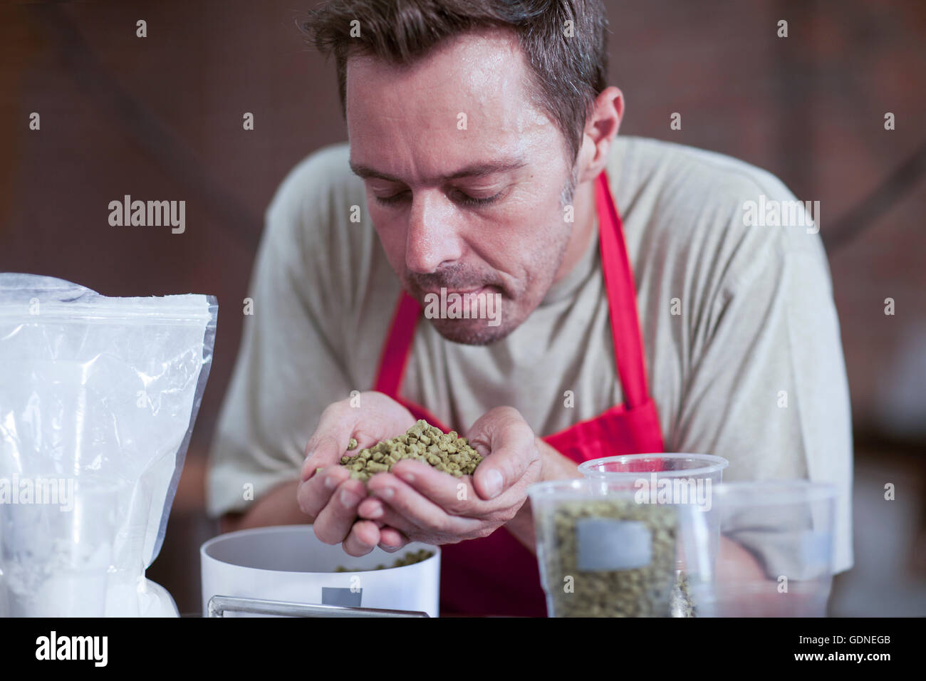 Man smelling handful of grains Stock Photo - Alamy