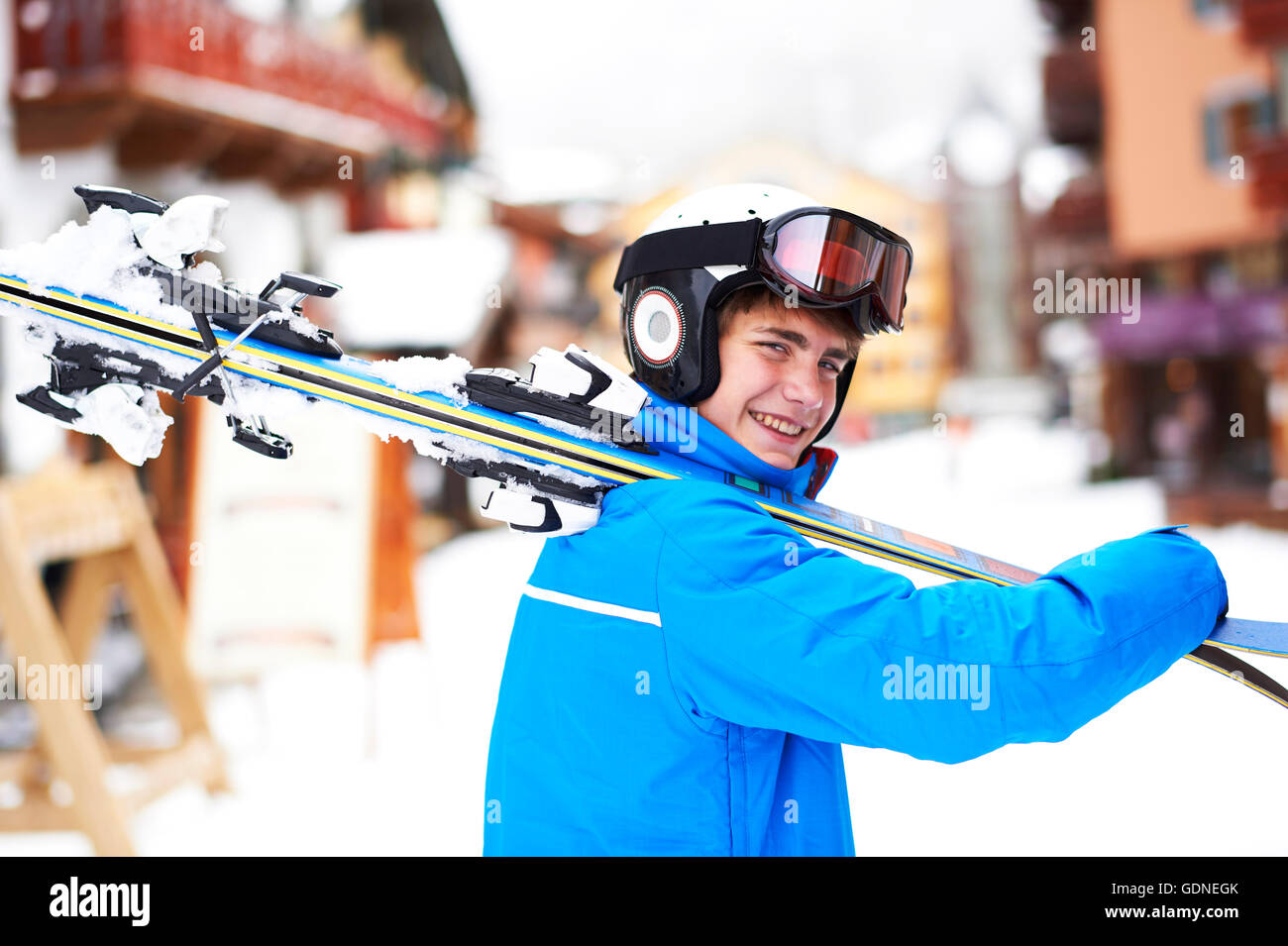Portrait of teenage boy carrying skis on shoulder Stock Photo - Alamy