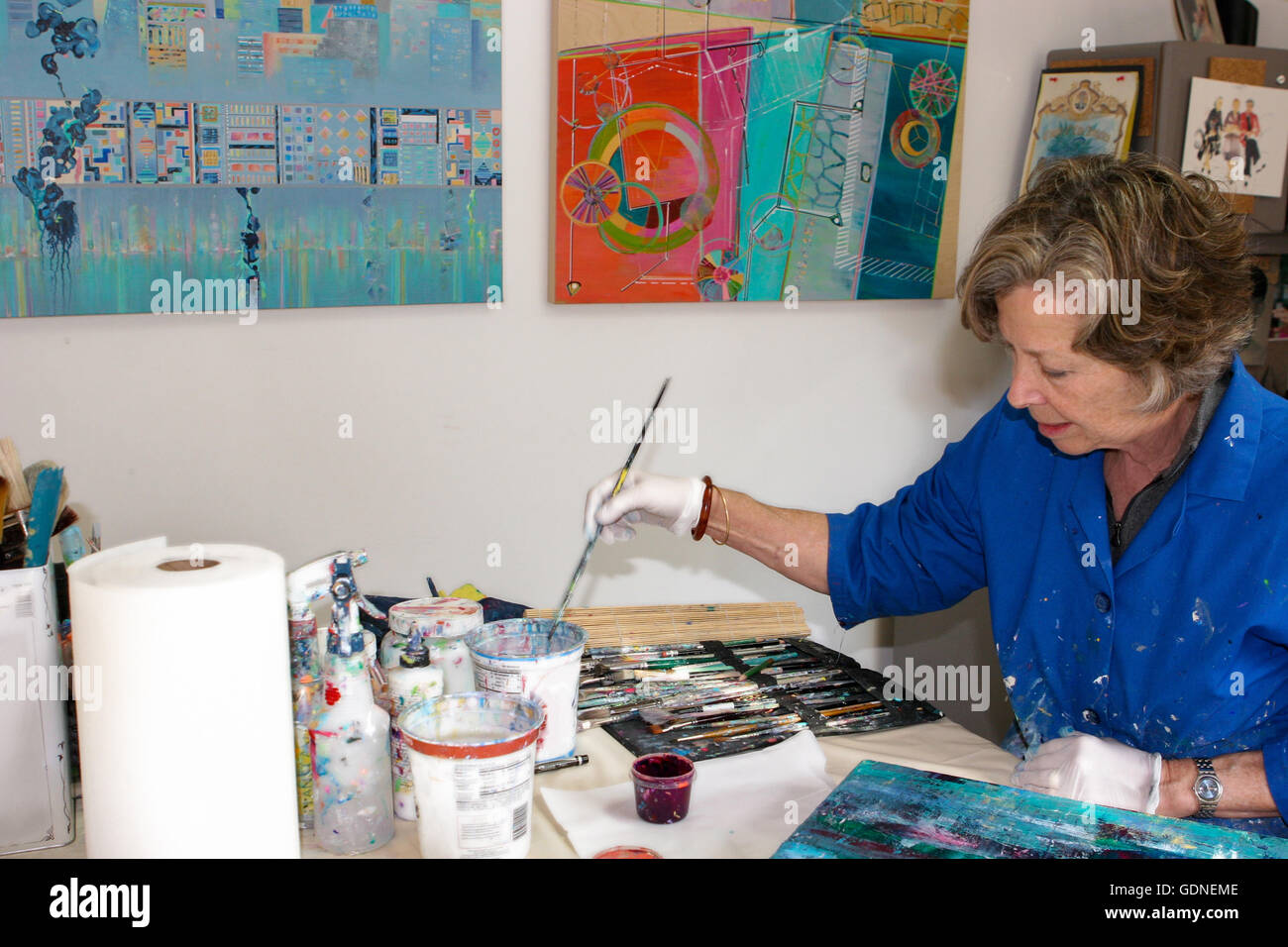 Artist painting canvas Stock Photo - Alamy