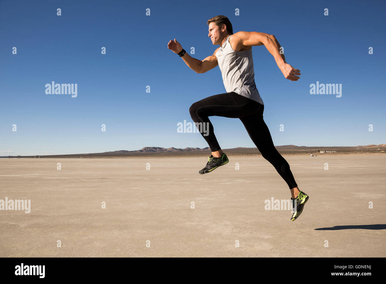 Male runner running on dry lake bed, El Mirage, California, USA Stock ...