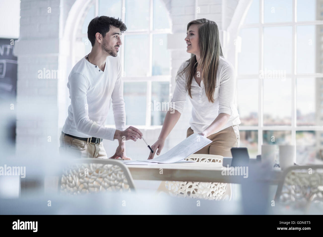 Young male and female designers meeting in design studio Stock Photo ...