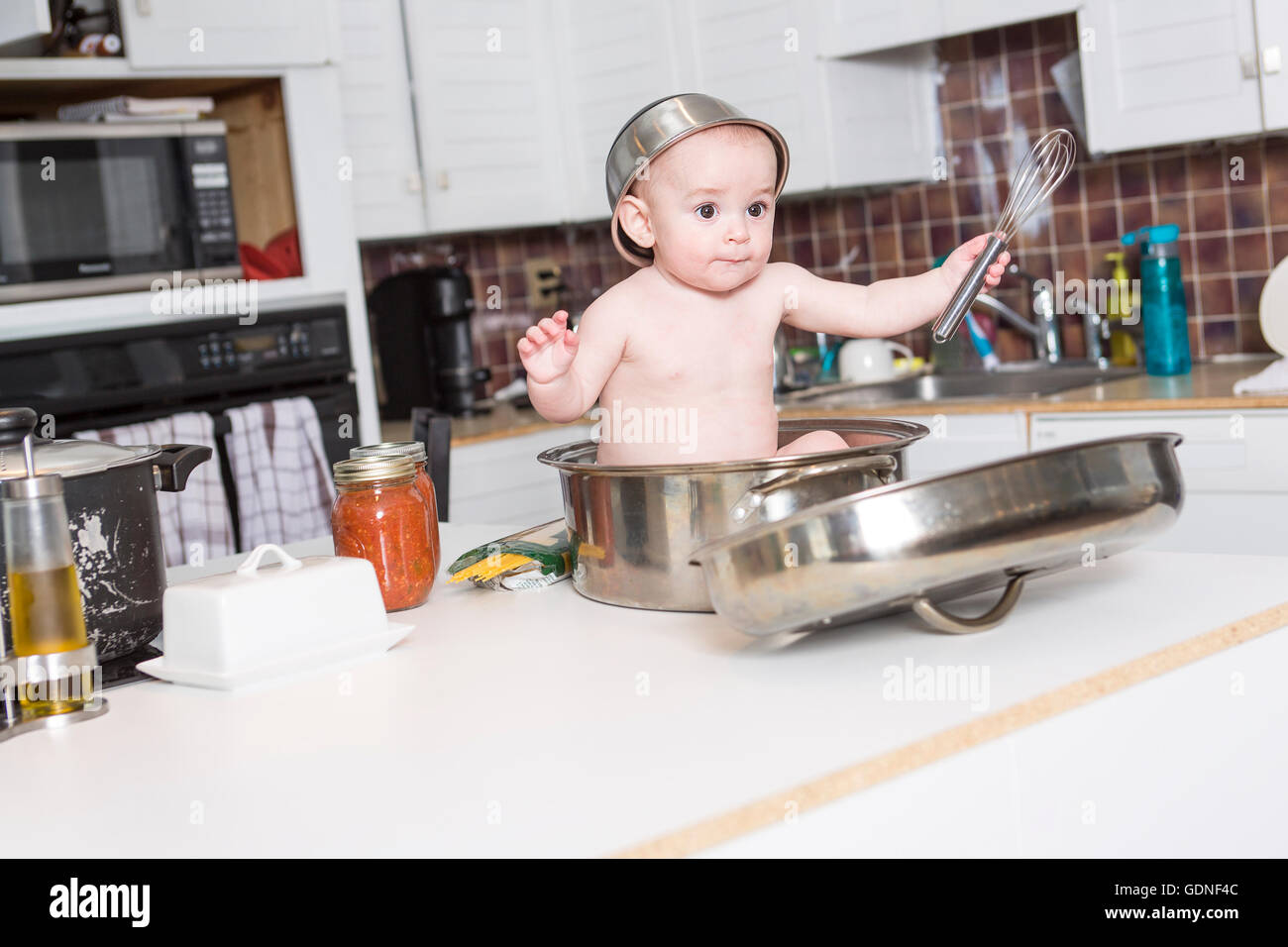 adorable baby cooking in kitchen Stock Photo - Alamy