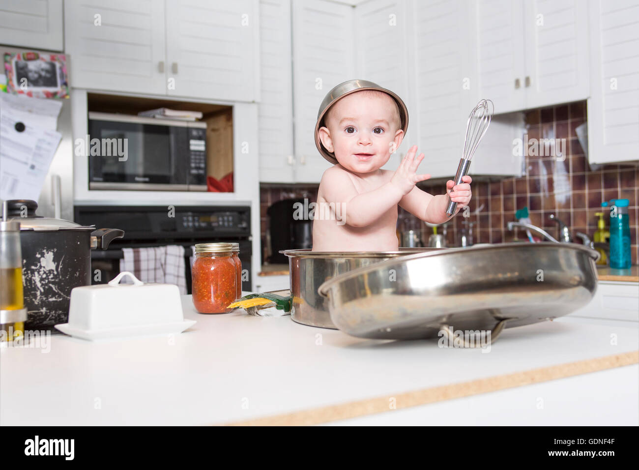 adorable baby cooking in kitchen Stock Photo - Alamy