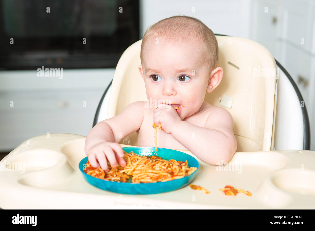 Little b eating her dinner and making a mess Stock Photo - Alamy