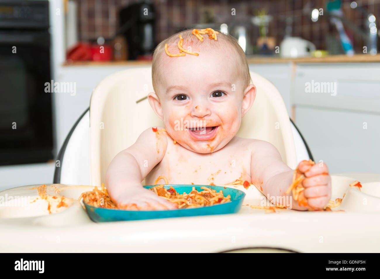 Little b eating her dinner and making a mess Stock Photo - Alamy