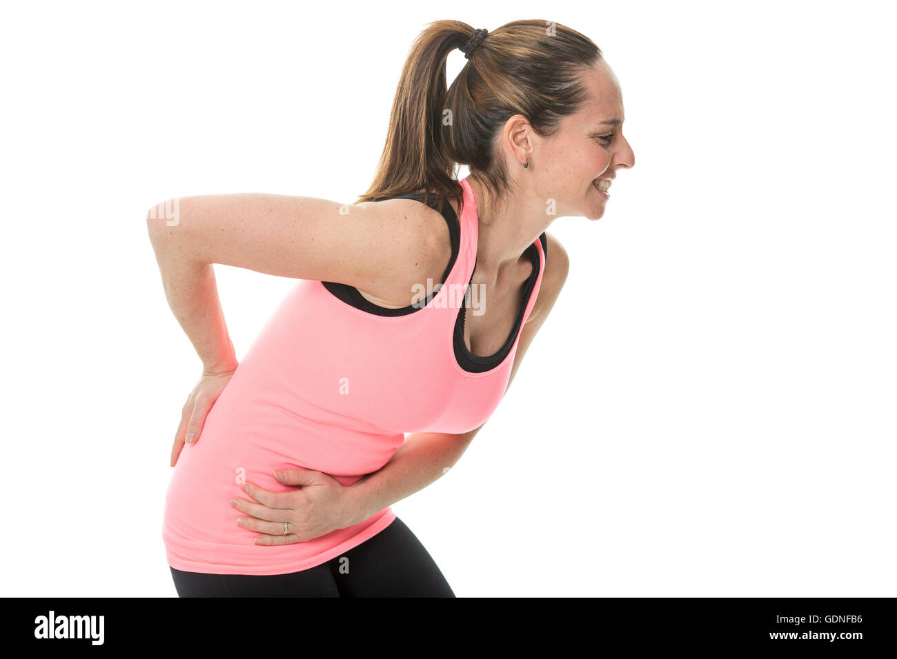 Fitness woman suffering from back pain Stock Photo - Alamy