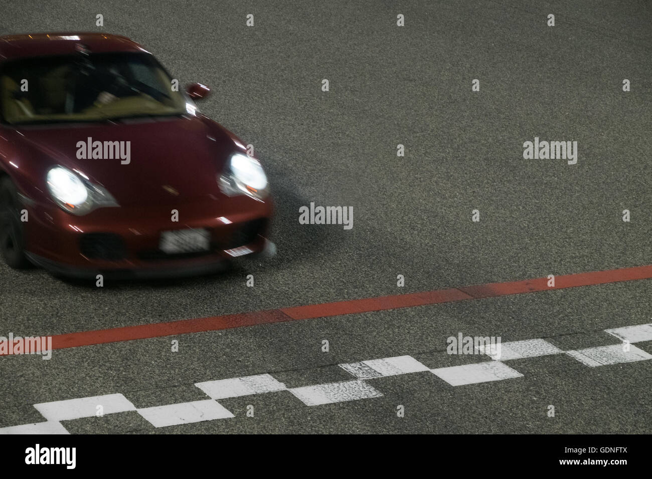 Sports car reaching the finish line in a race Stock Photo - Alamy