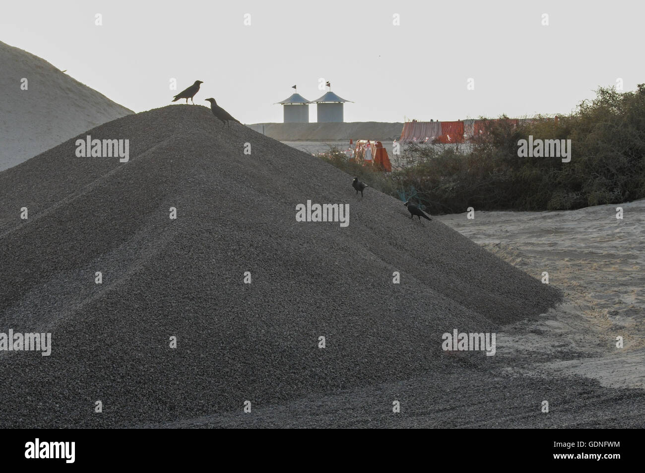 A pile of construction sand by a beach in Dubai Stock Photo - Alamy