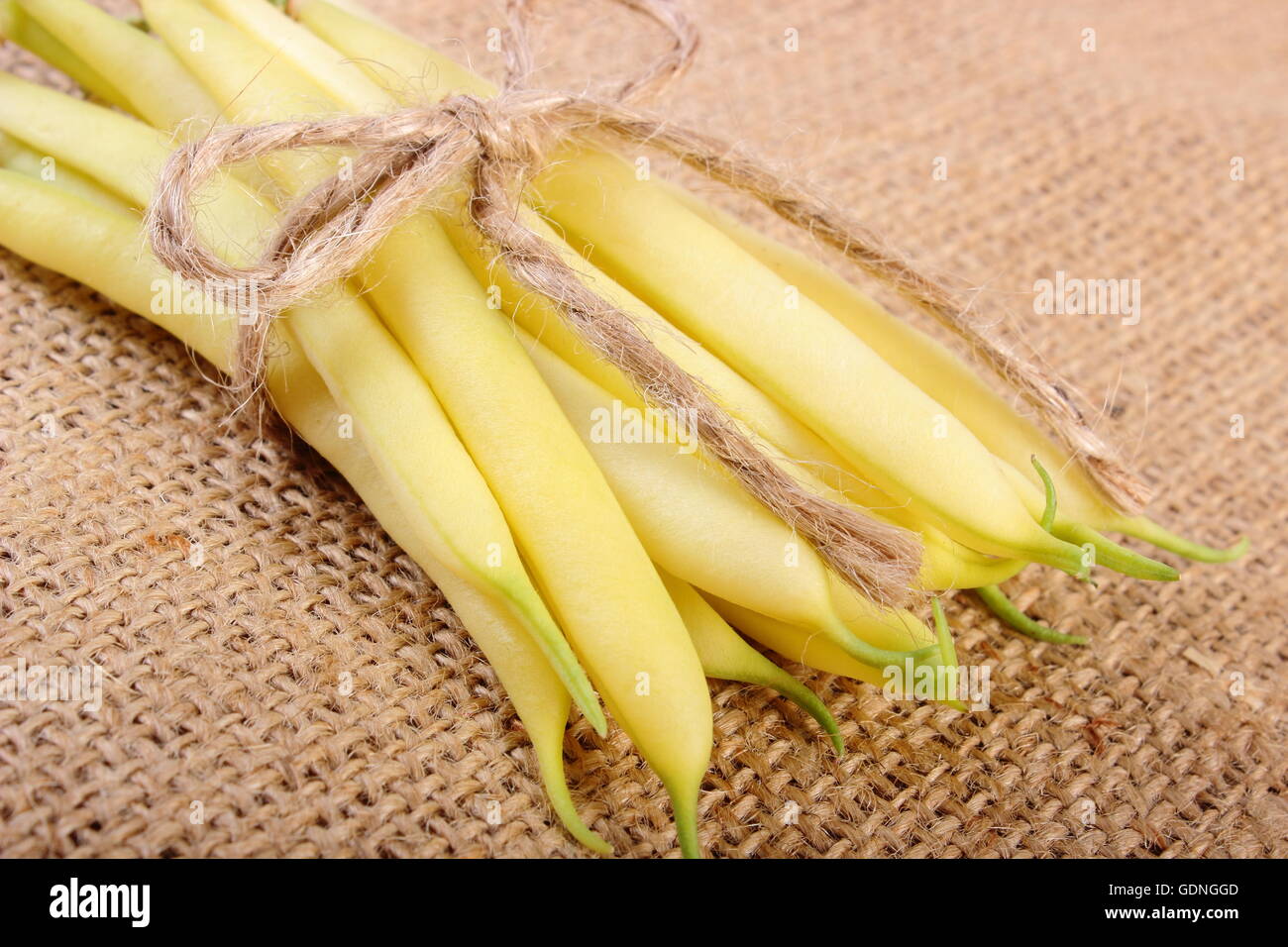 Stack of beans tied with string lying on jute canvas, healthy food and ...