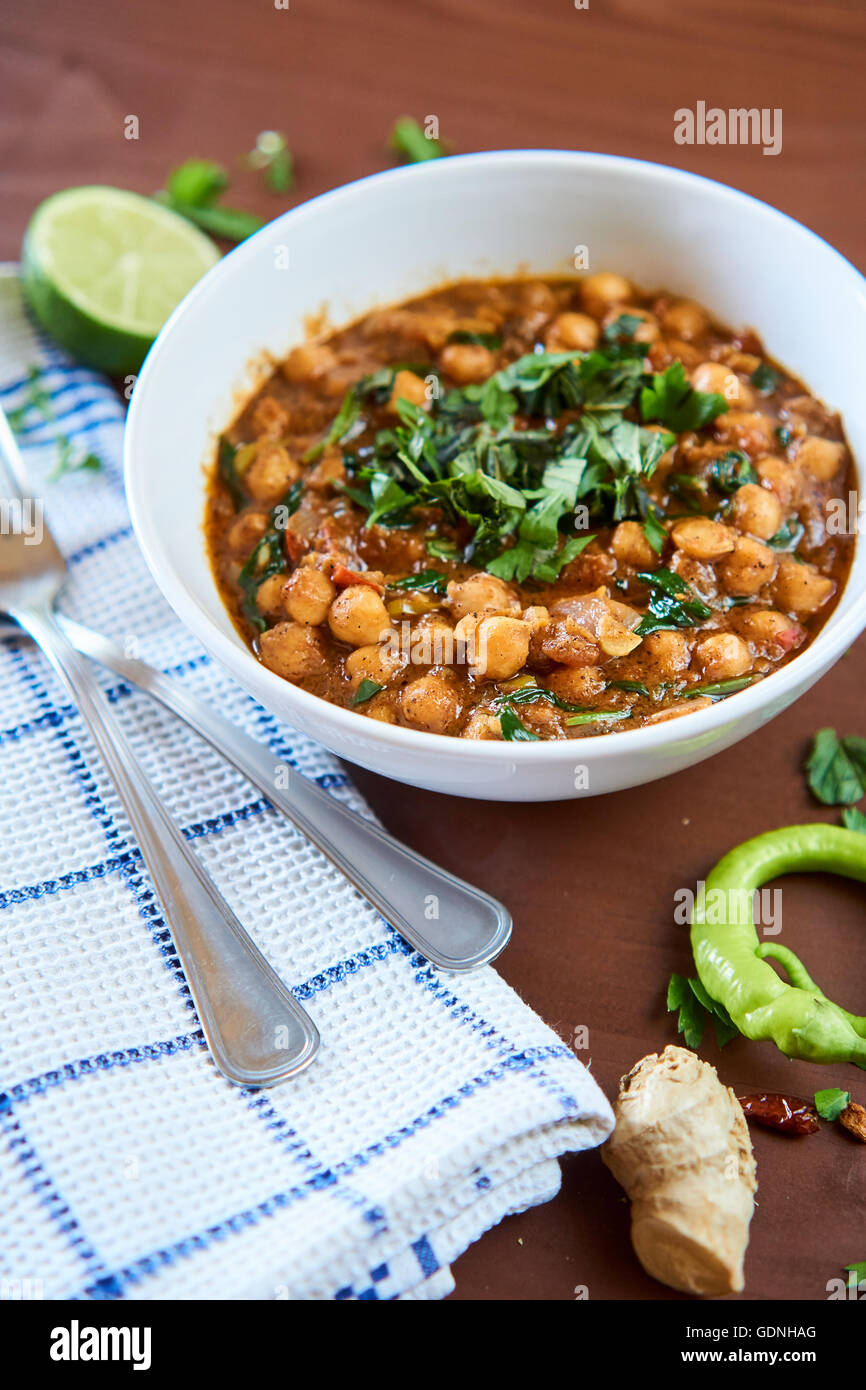 Chana masala dish, indian food on a wooden table with ingredients Stock ...