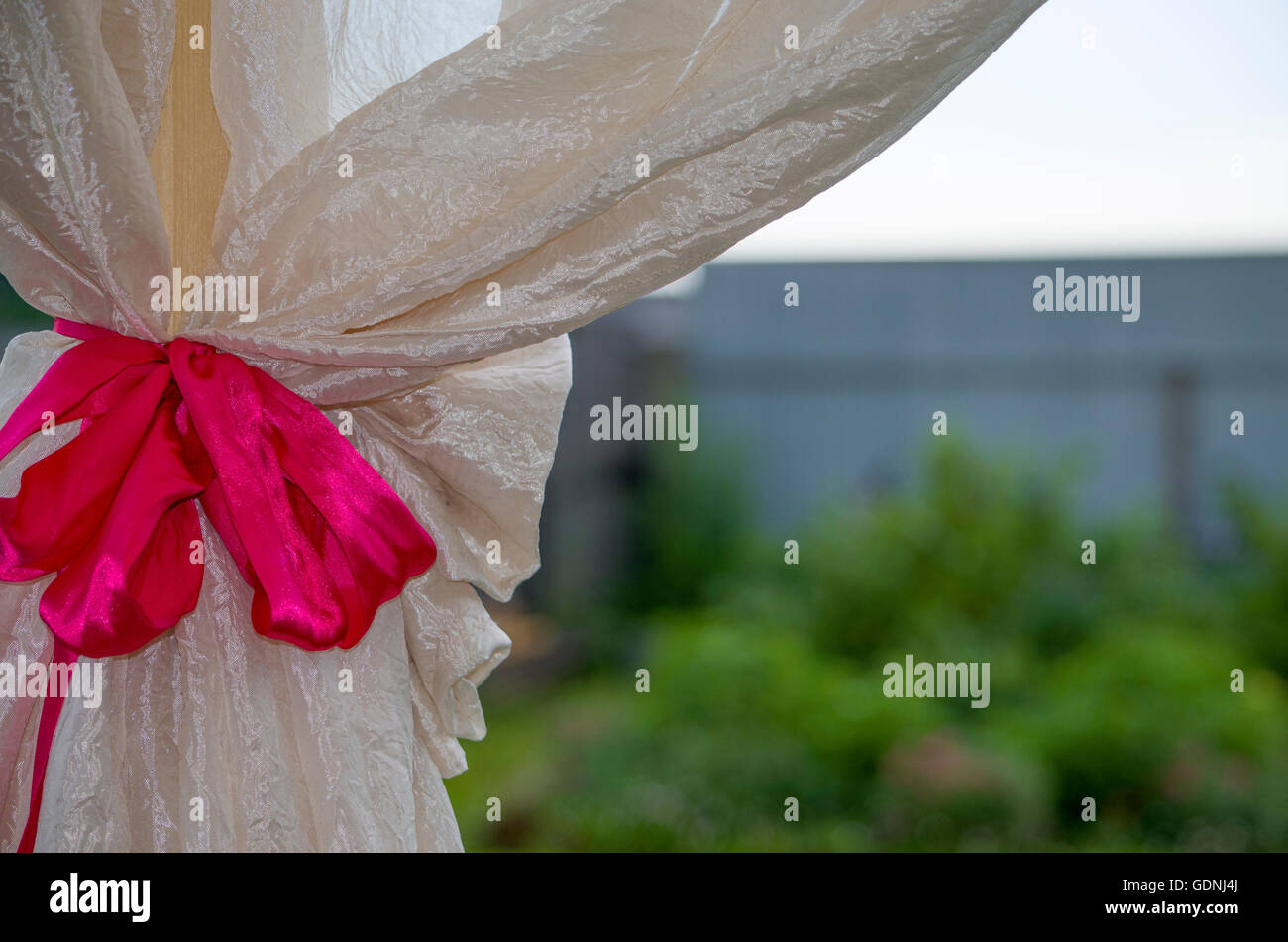 The curtain from matter reaped with a red bow the curtain,a bow, a look ...