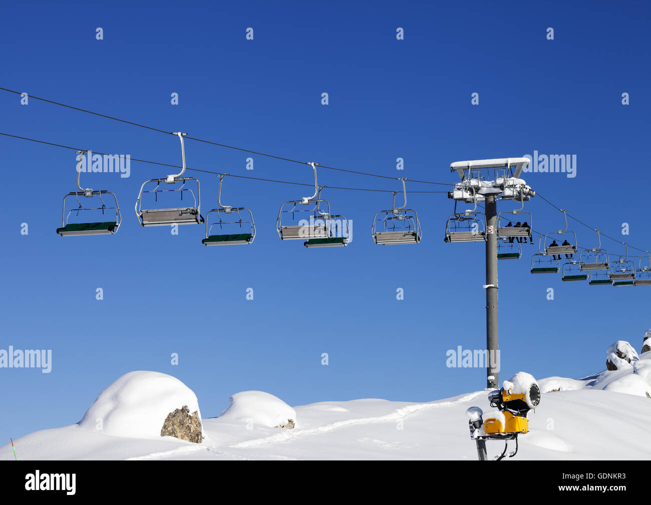 Chair-lift at ski resort at sun day after snowfall. Greater Caucasus ...