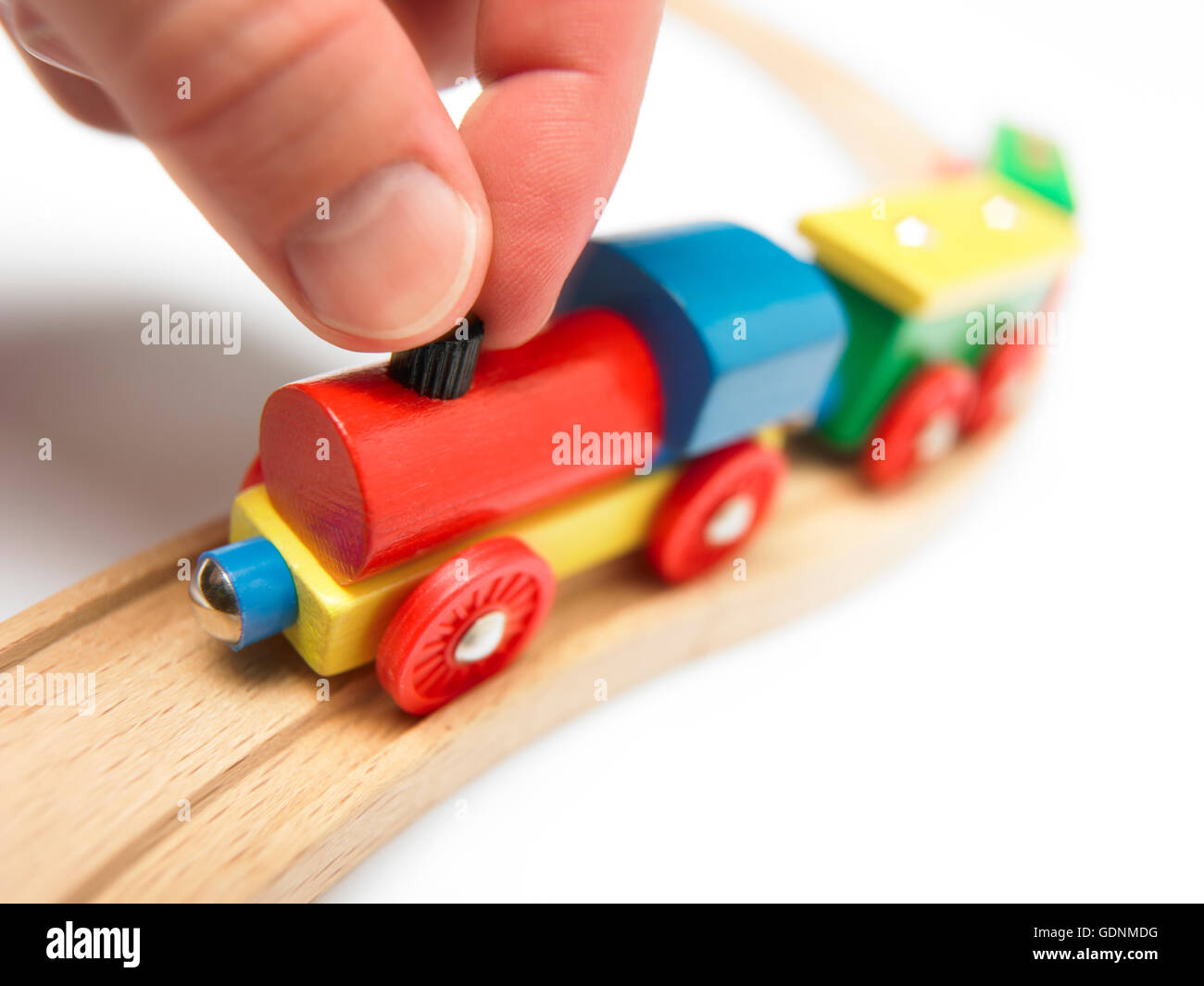 Colorful wooden toy train with hand isolated on white. Horizontal Stock ...