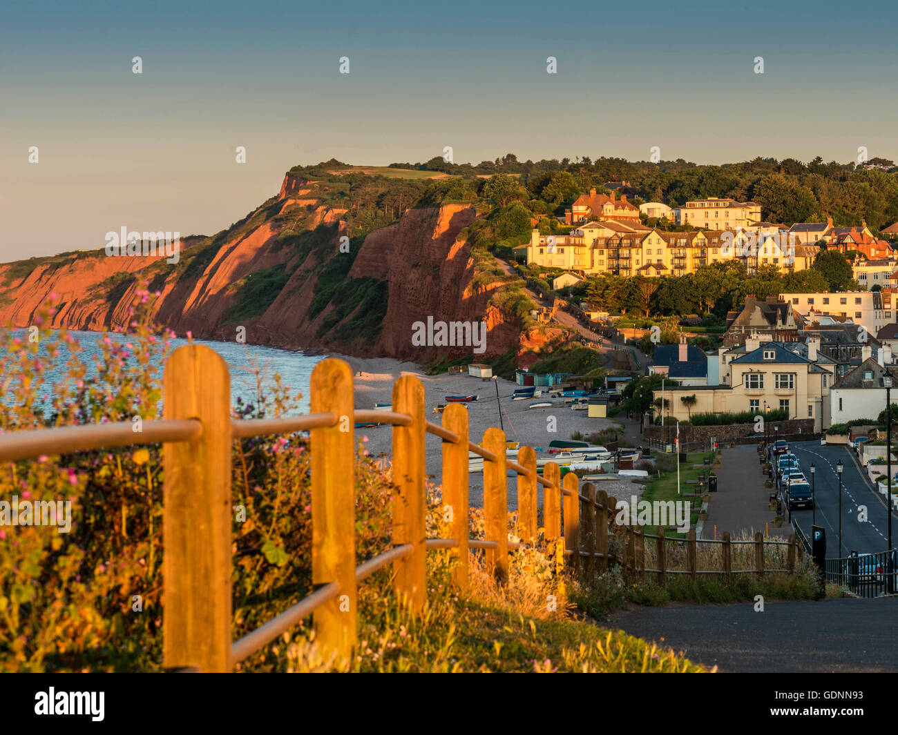 Landscape depicting sunrise over quaint seaside village, featuring ...
