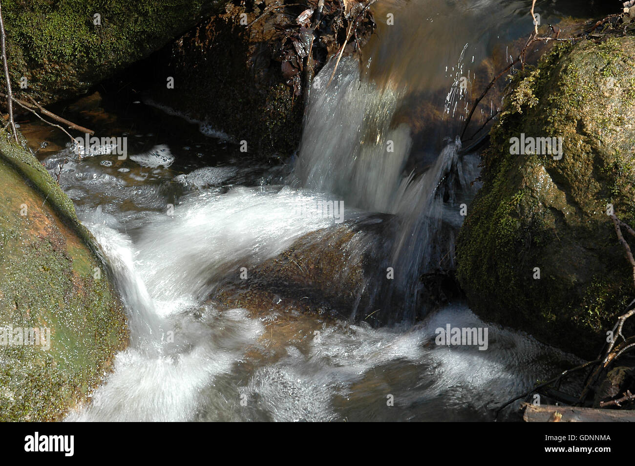 Stream water runs over stones hi-res stock photography and images - Alamy