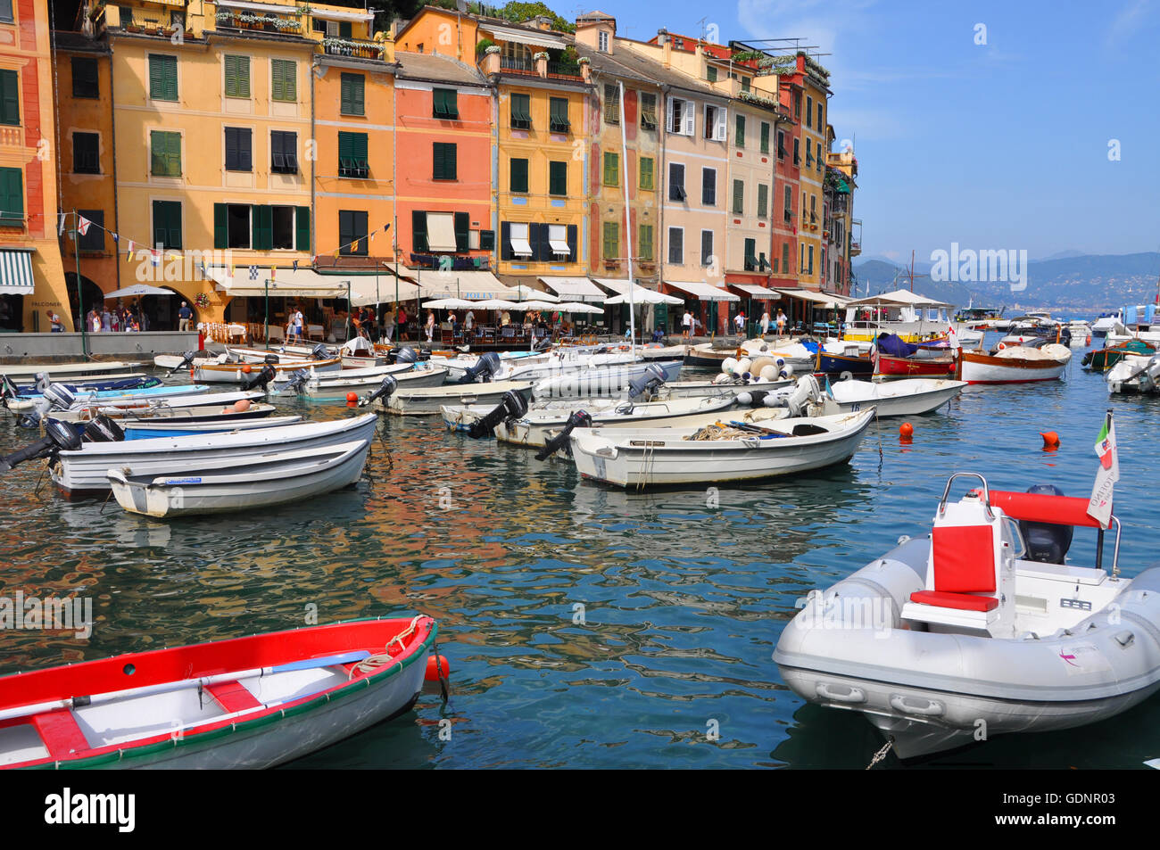 Portofino Harbor: small fishing boats floating on colorful water in ...