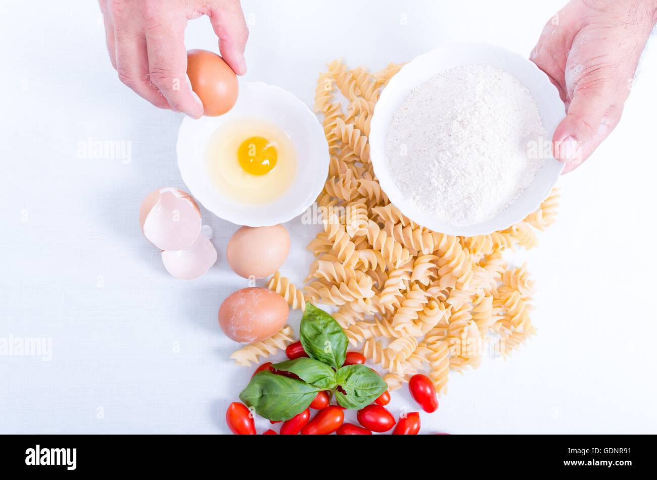 Fusilli pasta made by hand in the kitchen with natural ingredients ...