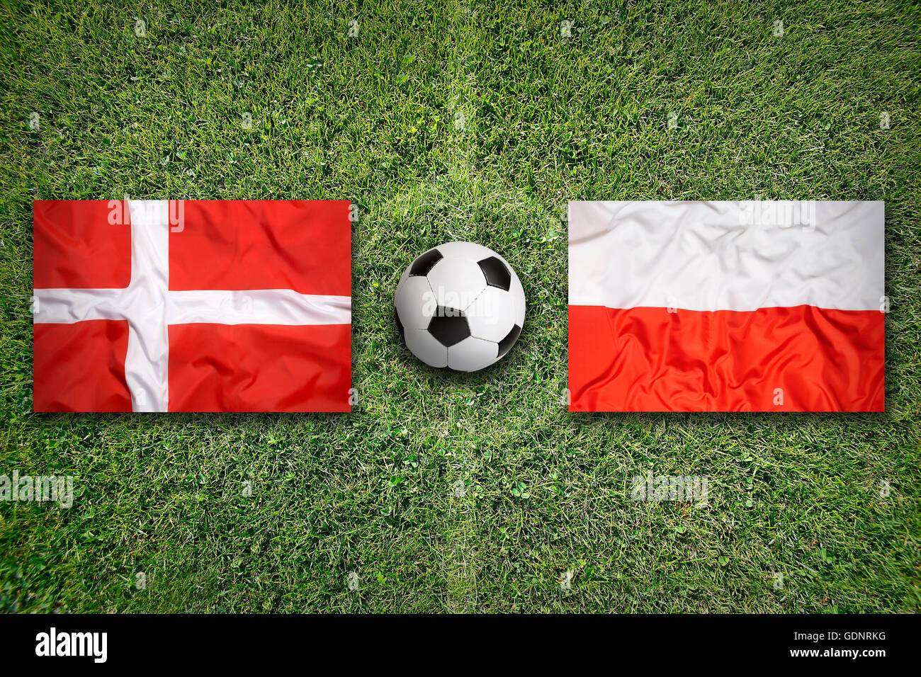 Denmark vs. Poland flags on green soccer field Stock Photo - Alamy