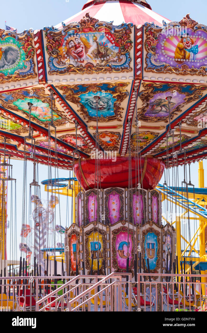 Colorful swing carousel carnival chair ride on a fairground in summer ...