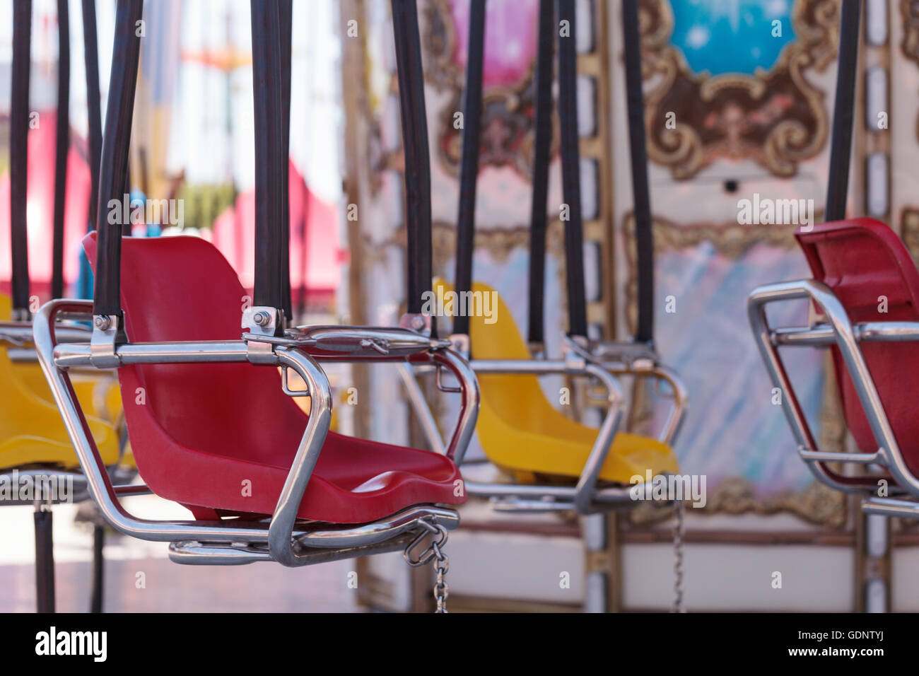 Colorful swing carousel carnival chair ride on a fairground in summer ...