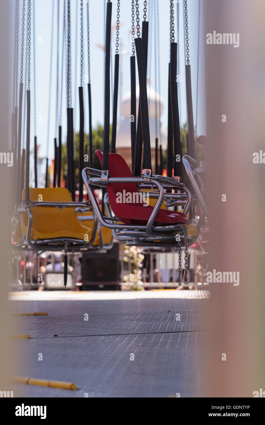 Colorful swing carousel carnival chair ride on a fairground in summer ...