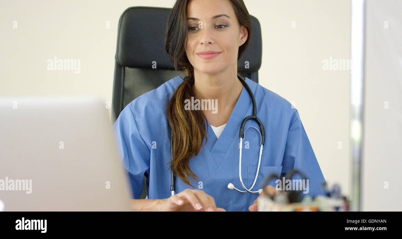 Beautiful female doctor at laptop computer Stock Photo - Alamy