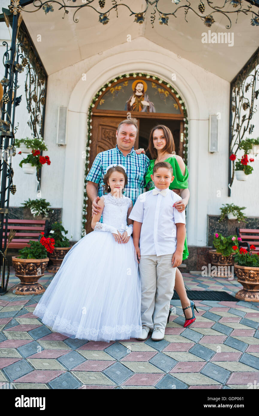 Happy family at first holy communion stay background church Stock Photo ...
