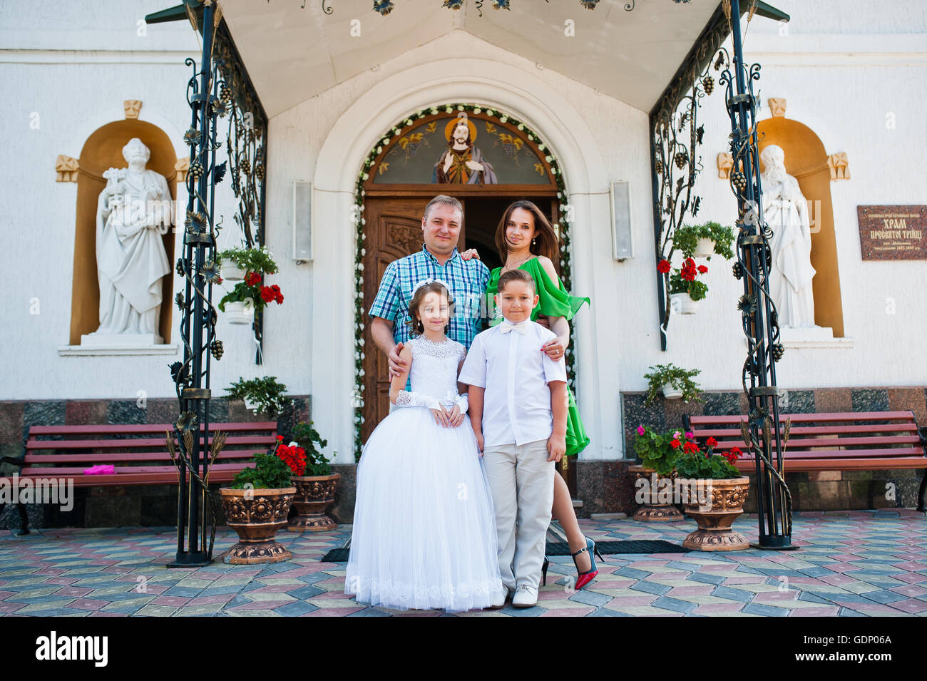 Happy family at first holy communion stay background church Stock Photo ...