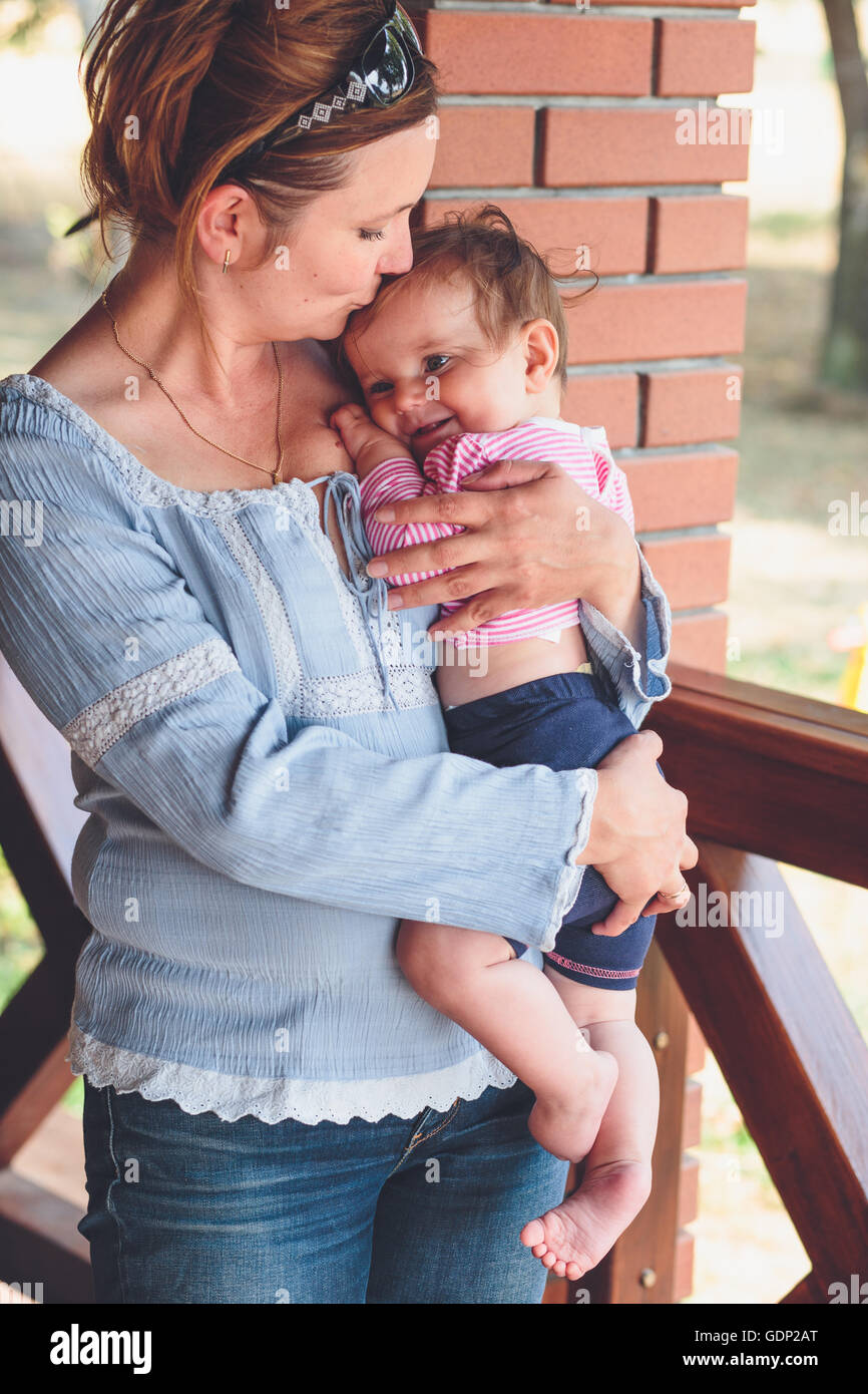 Mom hugging her little baby Stock Photo - Alamy
