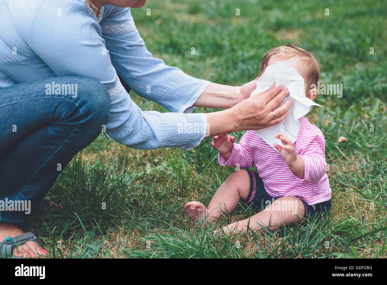Mom wiping nose her little daughter with a tissue Stock Photo - Alamy