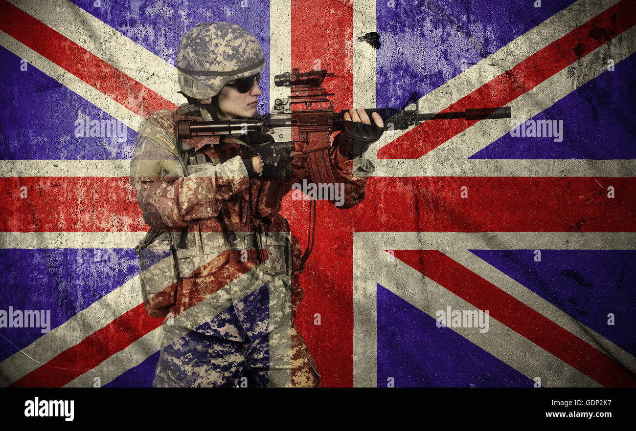 soldier holding rifle on a England flag background, double exposure ...