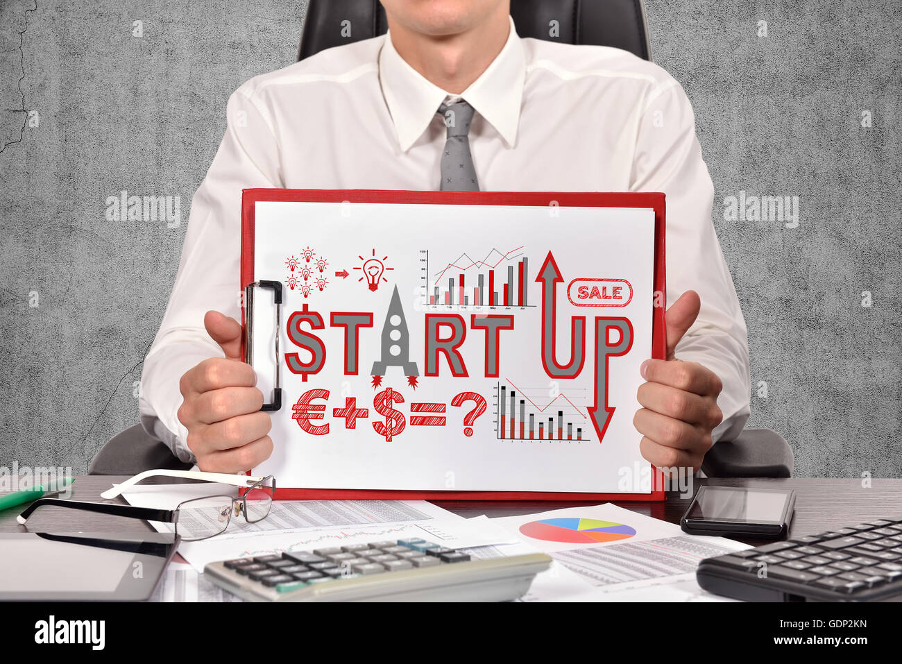 businessman holding clipboard with drawing start up scheme Stock Photo ...