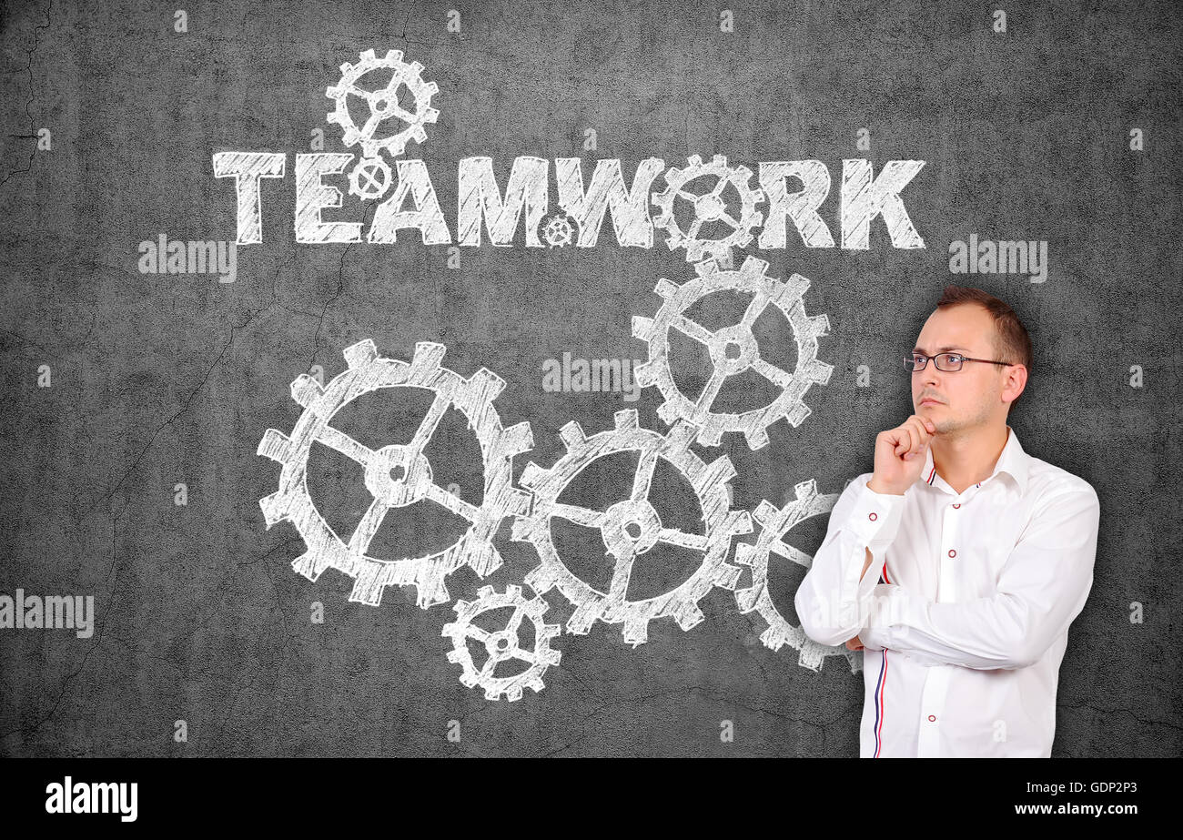 young businessman thinking and drawing teamwork concept on concrete ...