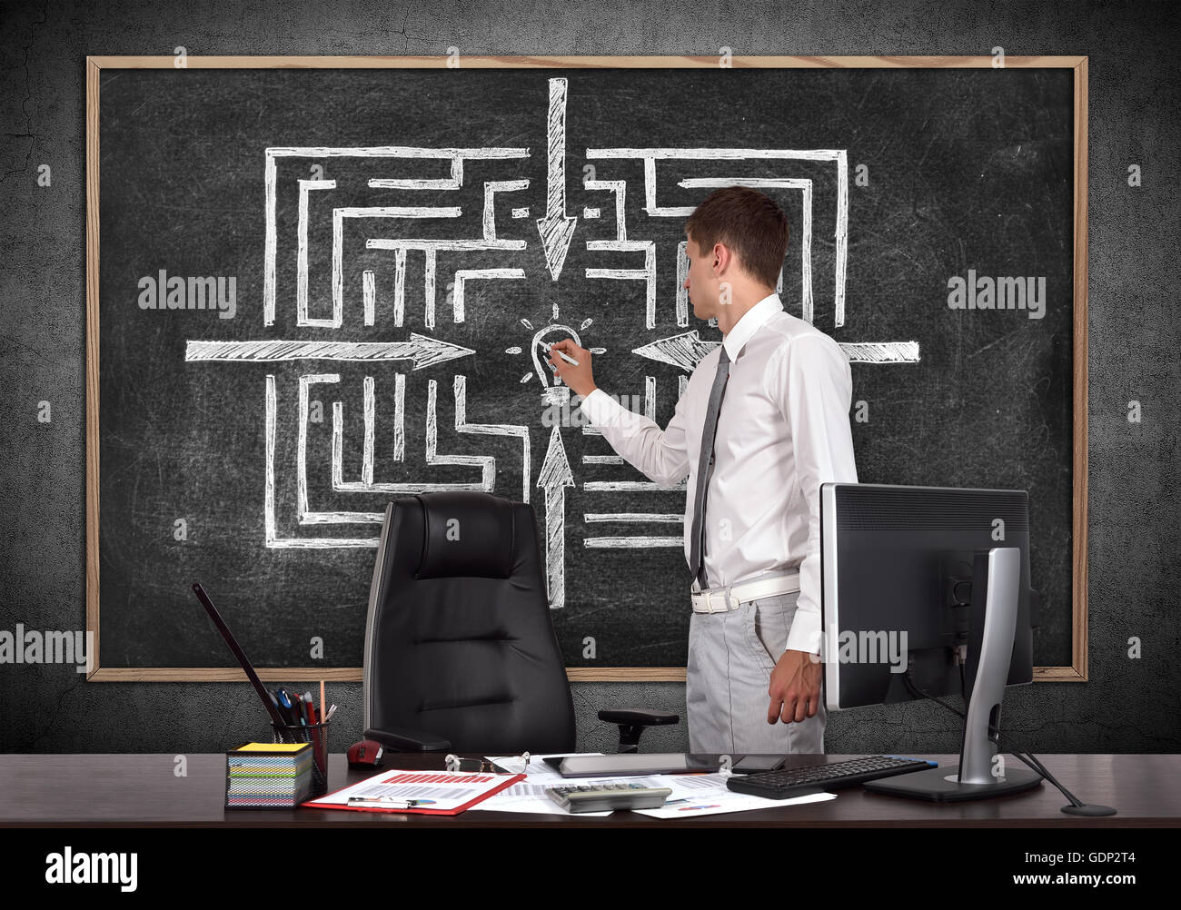 businessman in office drawing labyrinth on blackboard Stock Photo - Alamy