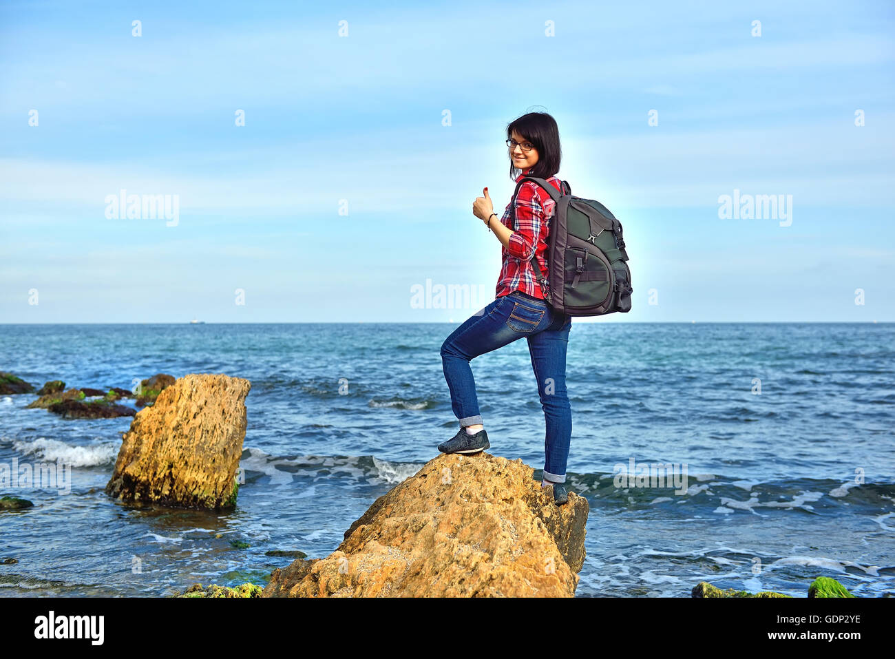 woman tourist standing on rock and showing thumb up Stock Photo - Alamy