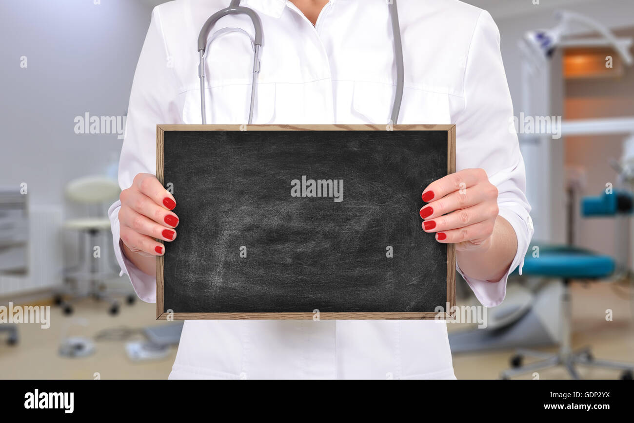 doctor standing in clinic and holding blank chalk board Stock Photo - Alamy