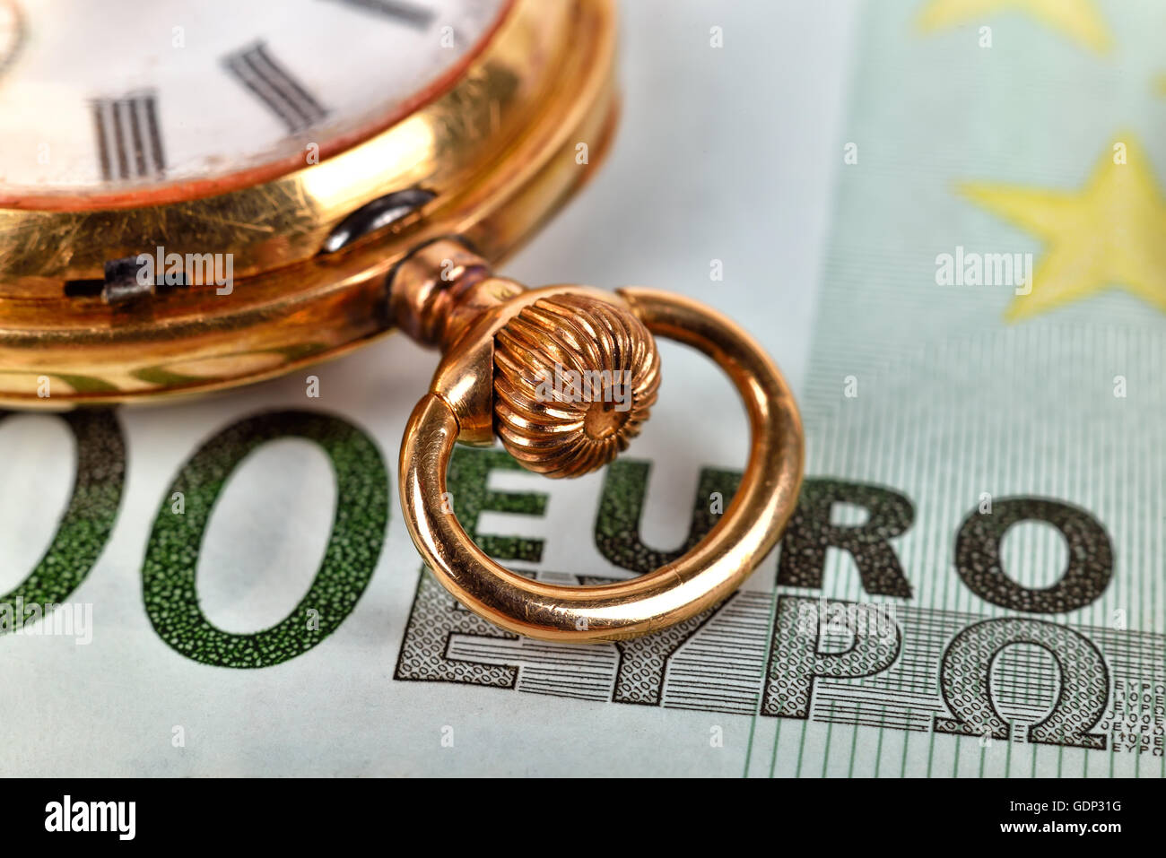 golden pocket watch and euro bills, extra close up Stock Photo - Alamy