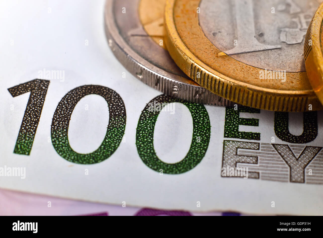 Euro coins and one hundred euro banknotes, close up Stock Photo - Alamy