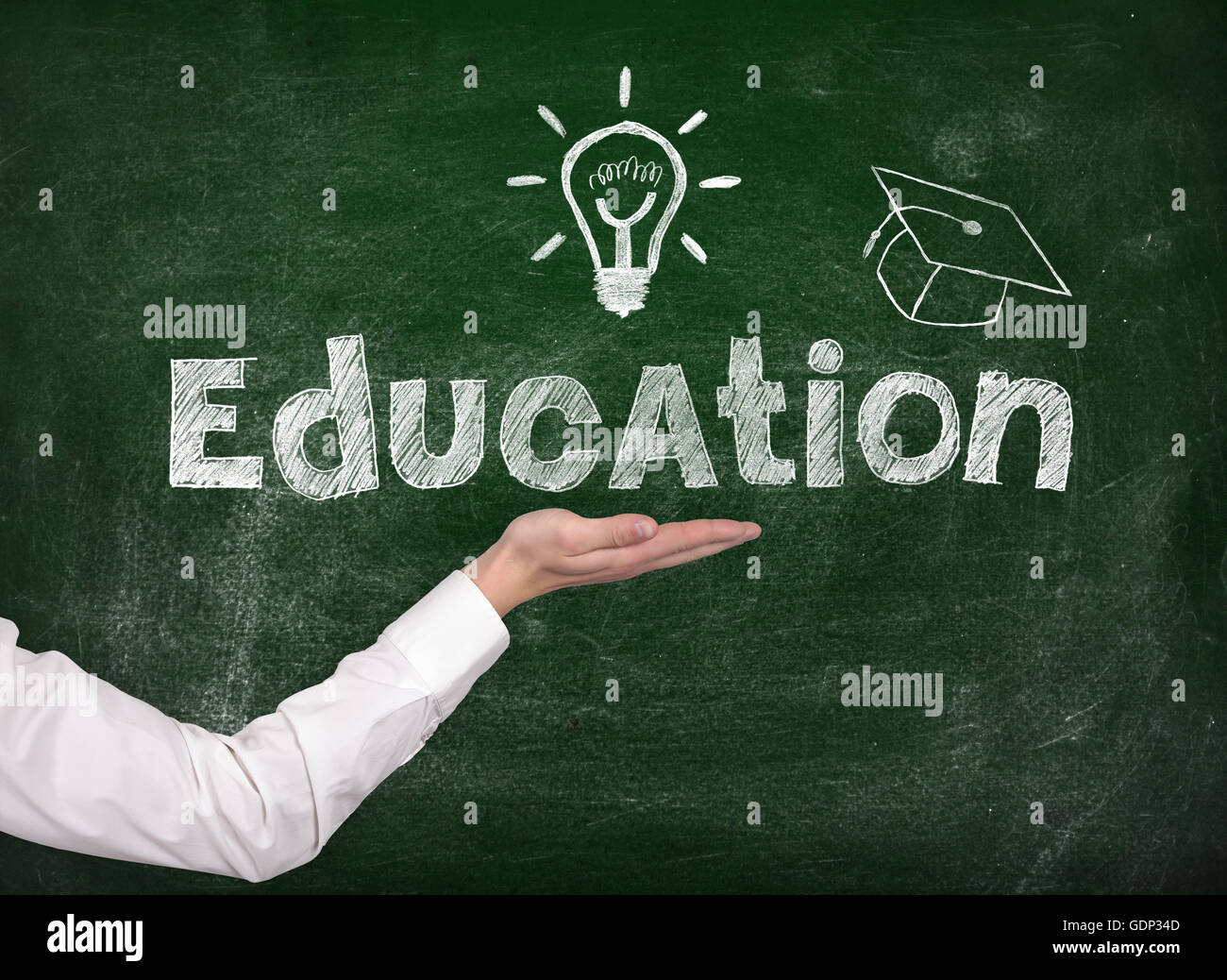 hand holding education symbol drawing on green chalkboard Stock Photo ...