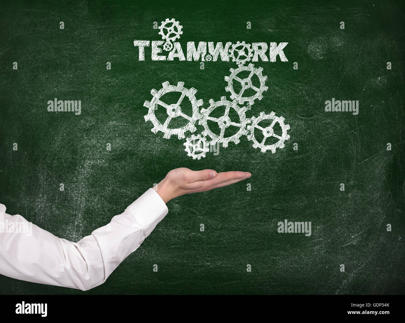 hand holding teamwork concept drawing on green chalkboard Stock Photo ...