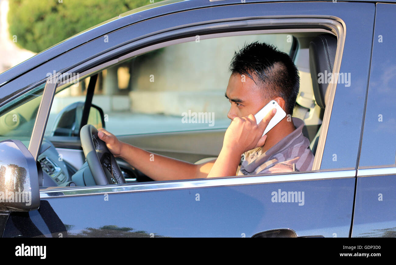 Young man calling during he drives Stock Photo - Alamy