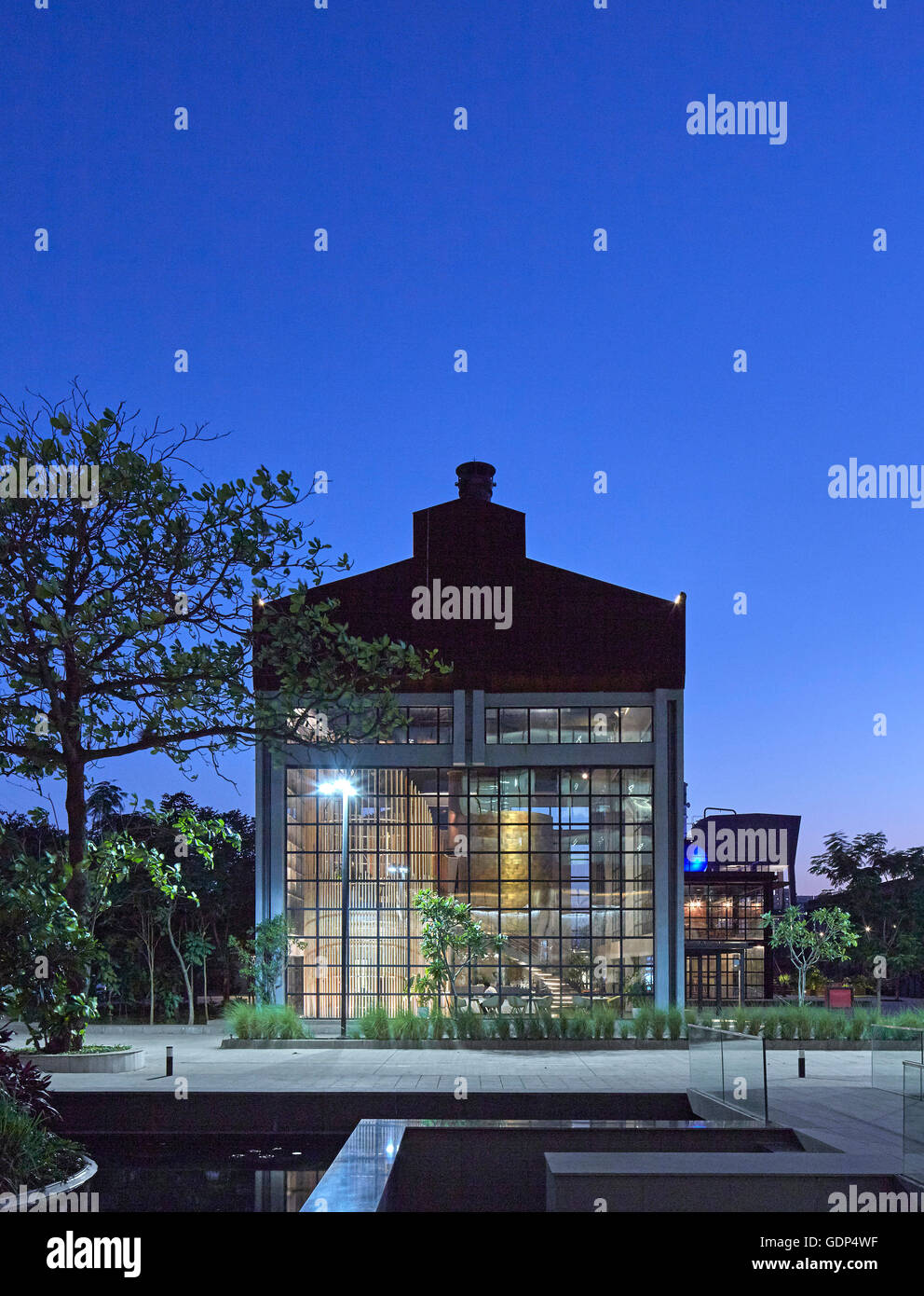 Dusk view looking into converted industrial building. Imagine Studio at ...