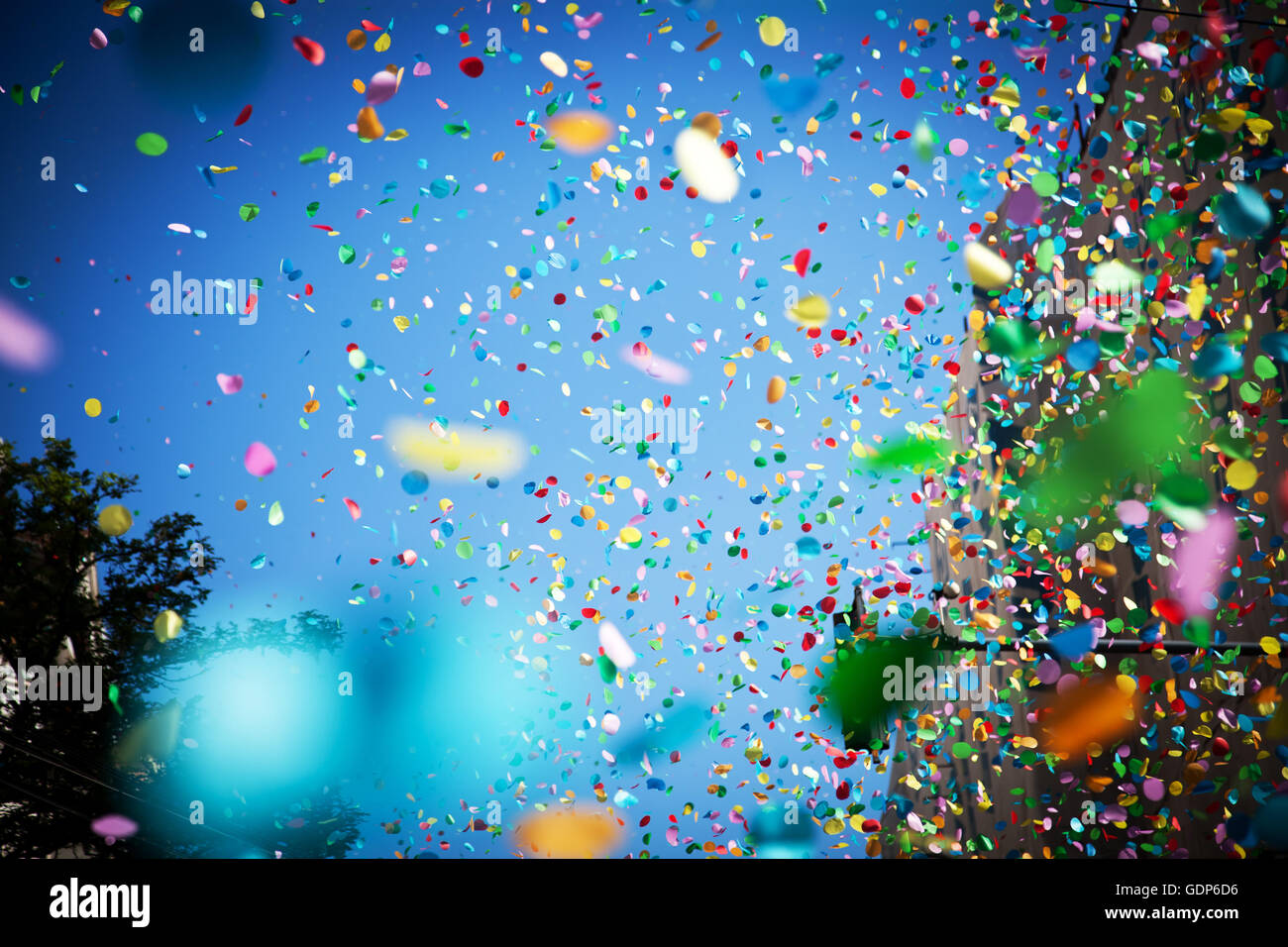 falling confetti in the city festival on blue sky background Stock ...