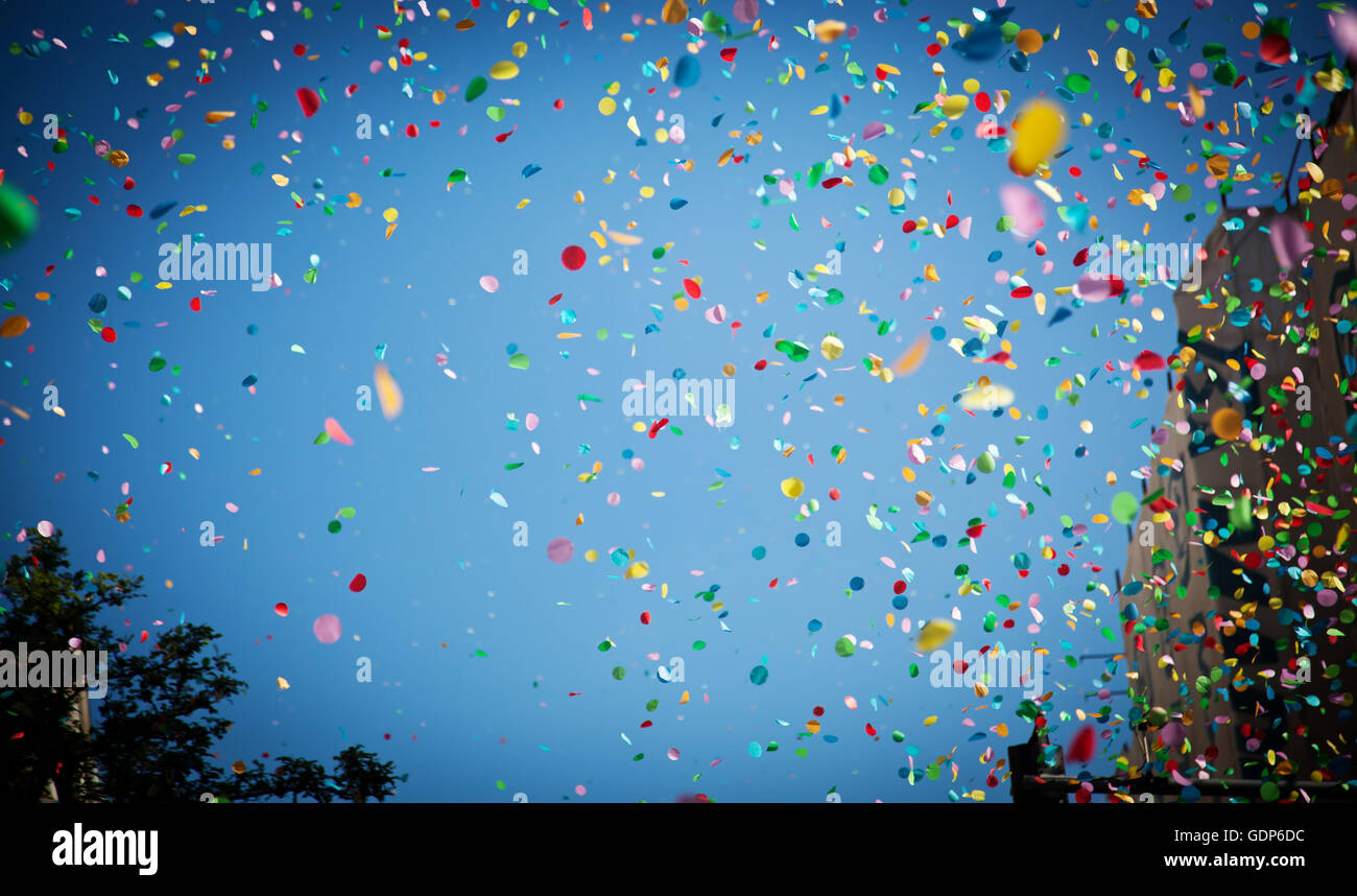 falling confetti in the city festival on blue sky background Stock ...