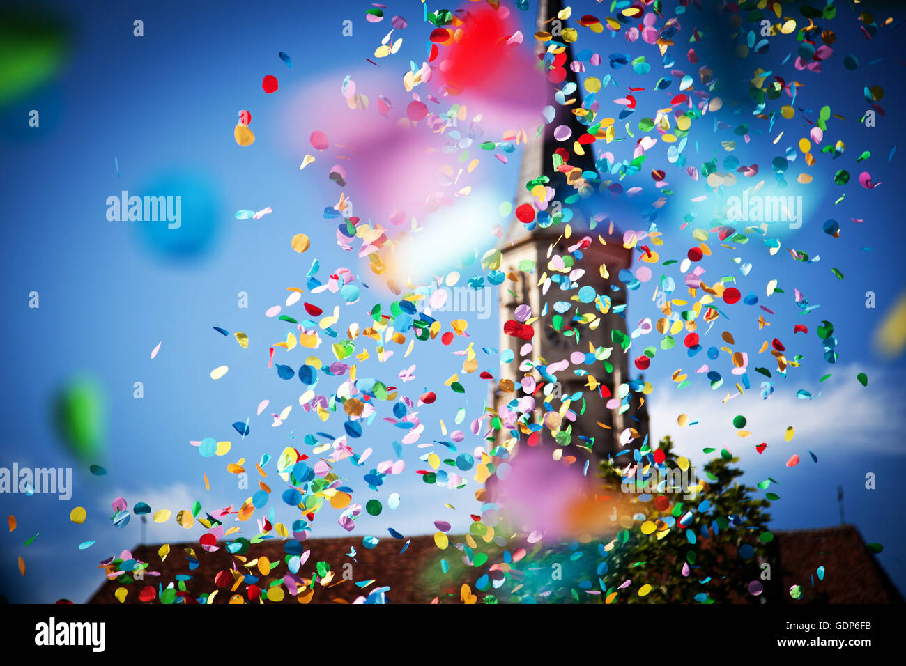 falling confetti in the city festival on blue sky background Stock ...