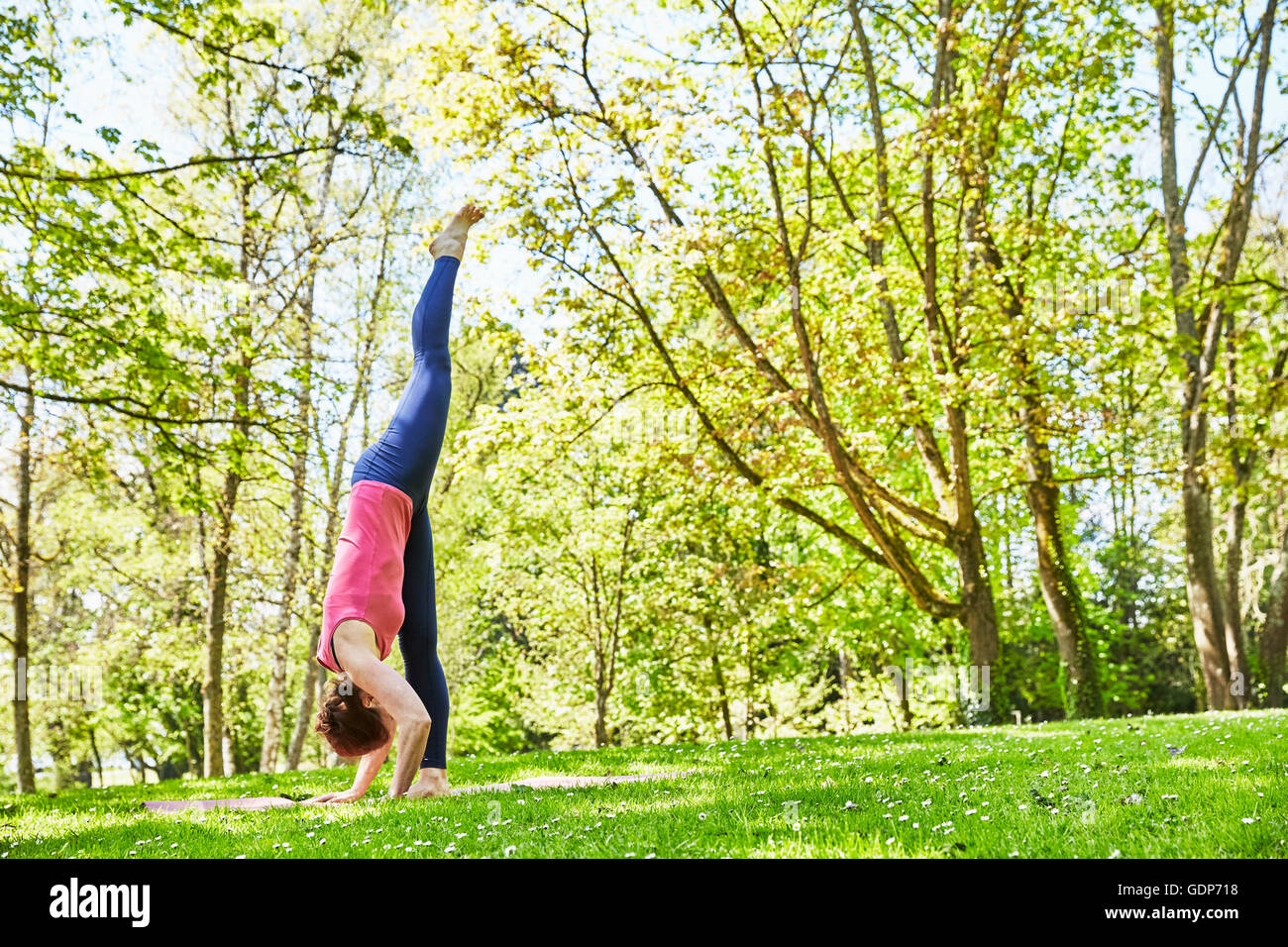Side view of woman doing handstand Stock Photo - Alamy